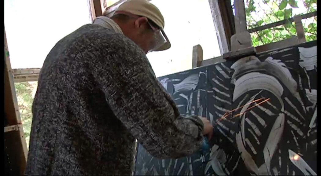 Craig Cameron working on a 'fridge door canvas' at Cowsnest Community ...