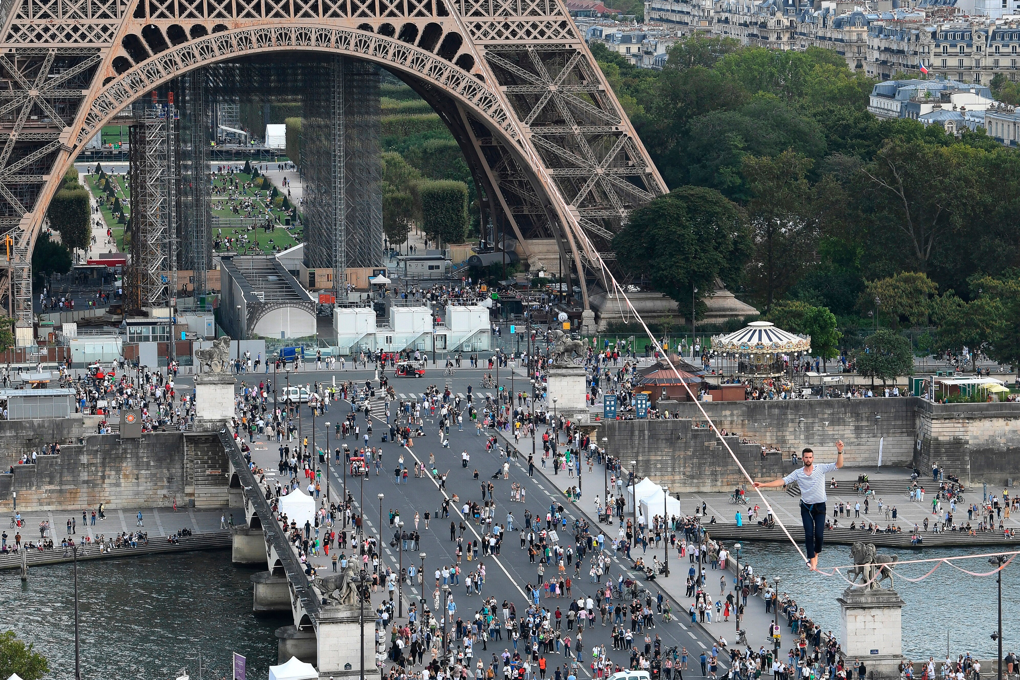 French tightrope walker crosses Paris river from Eiffel Tower to ...
