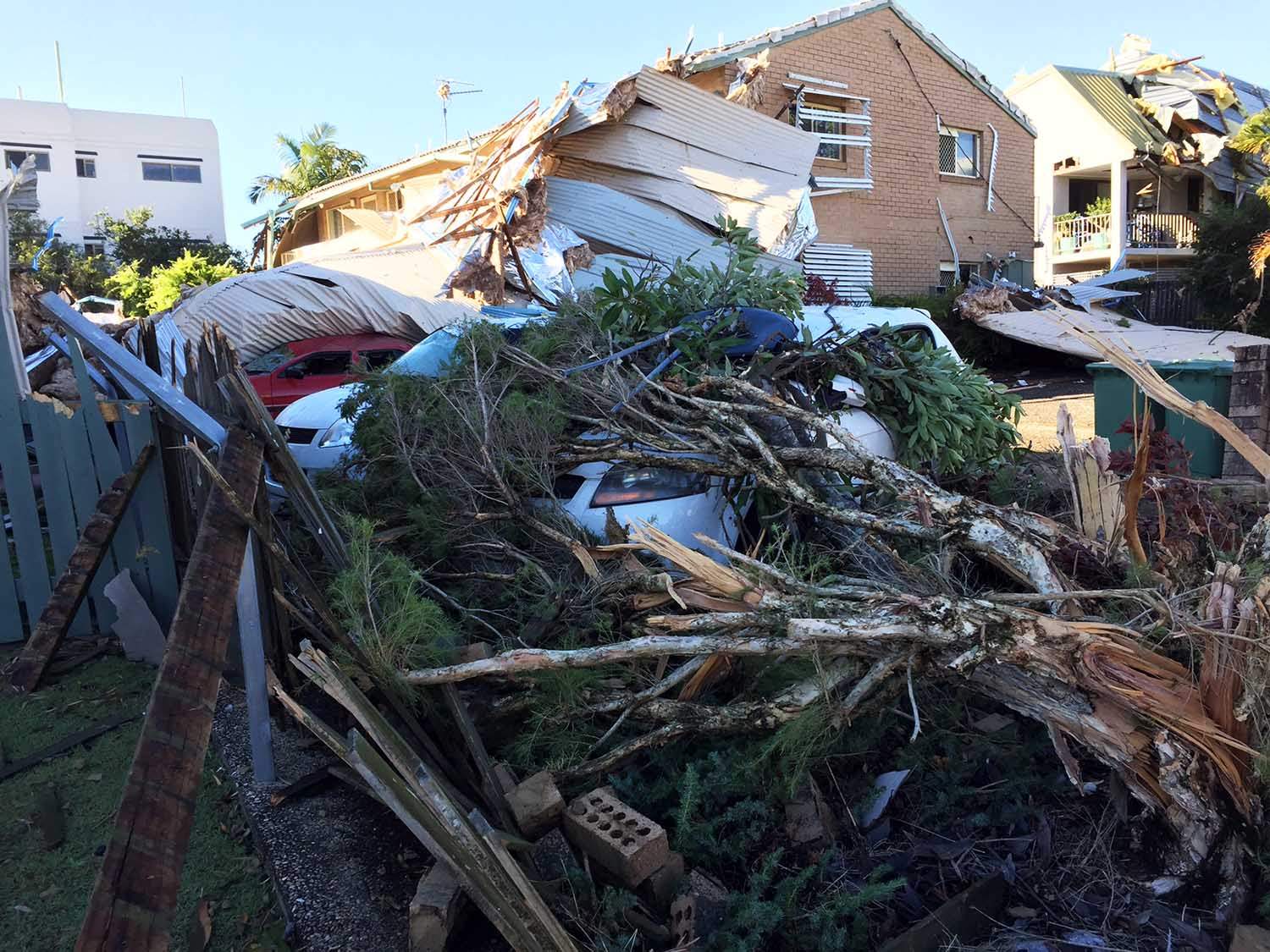 Strong winds tear roofs from unit blocks, trashing cars in Mooloolaba ...