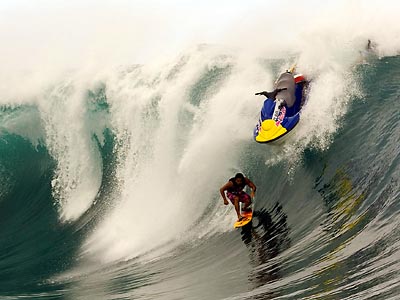 Big wave rider battles wave, jetski - ABC News