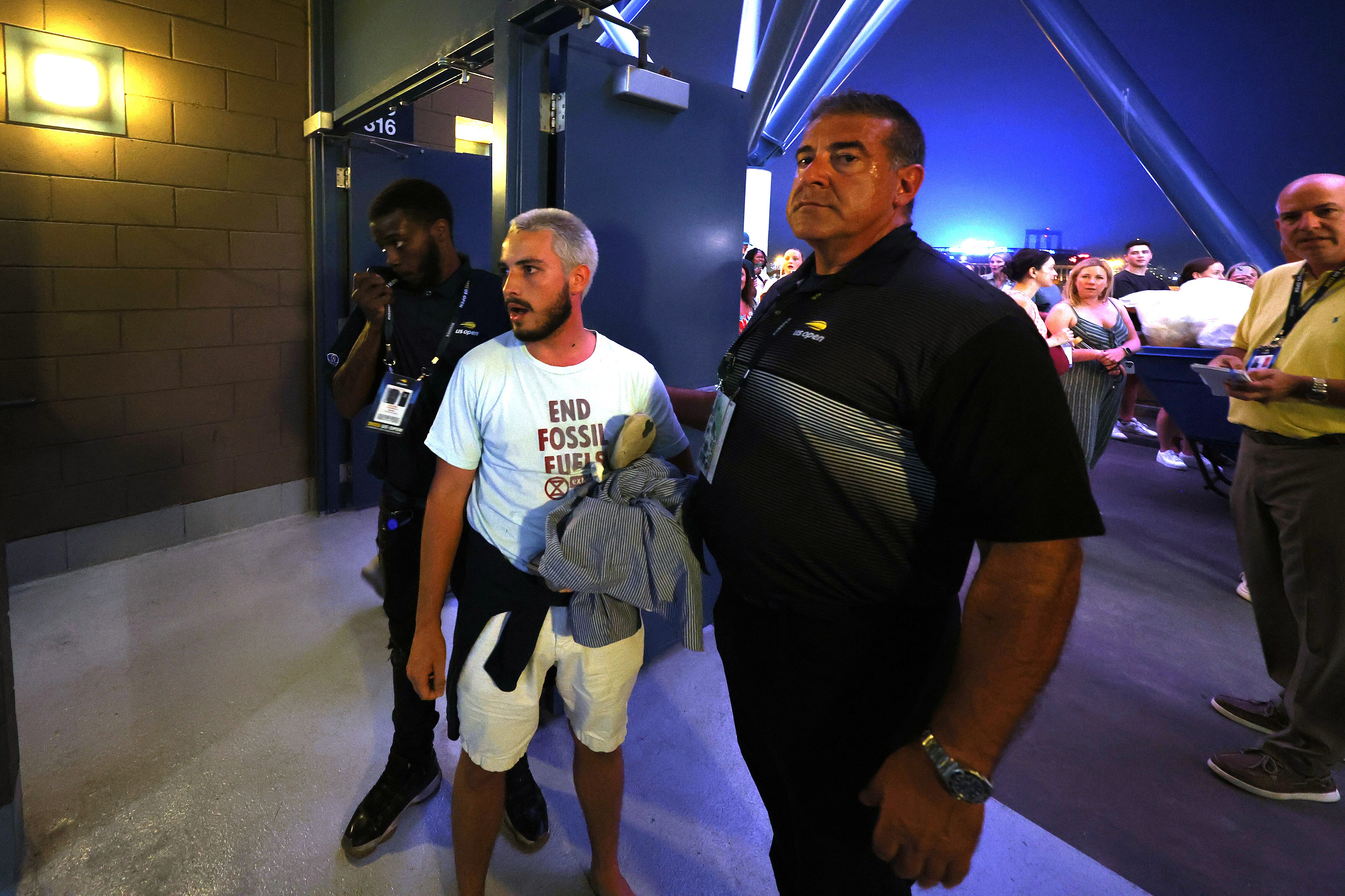 Environmental activist glues his feet to the ground as protest ...