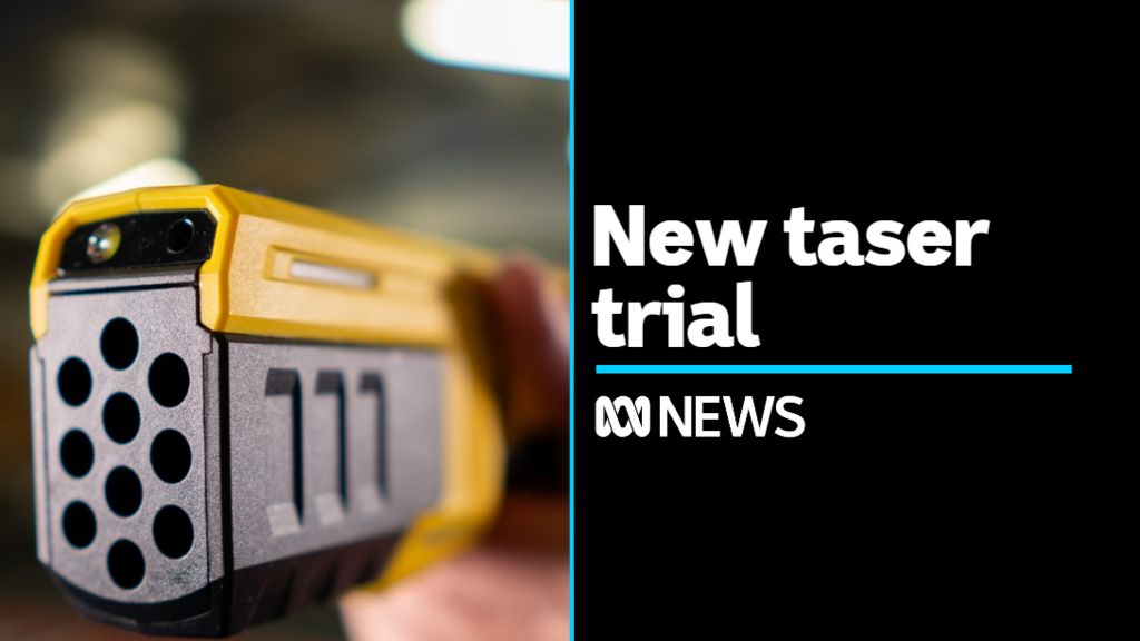 Police officer showing the different between current and new tasers ...