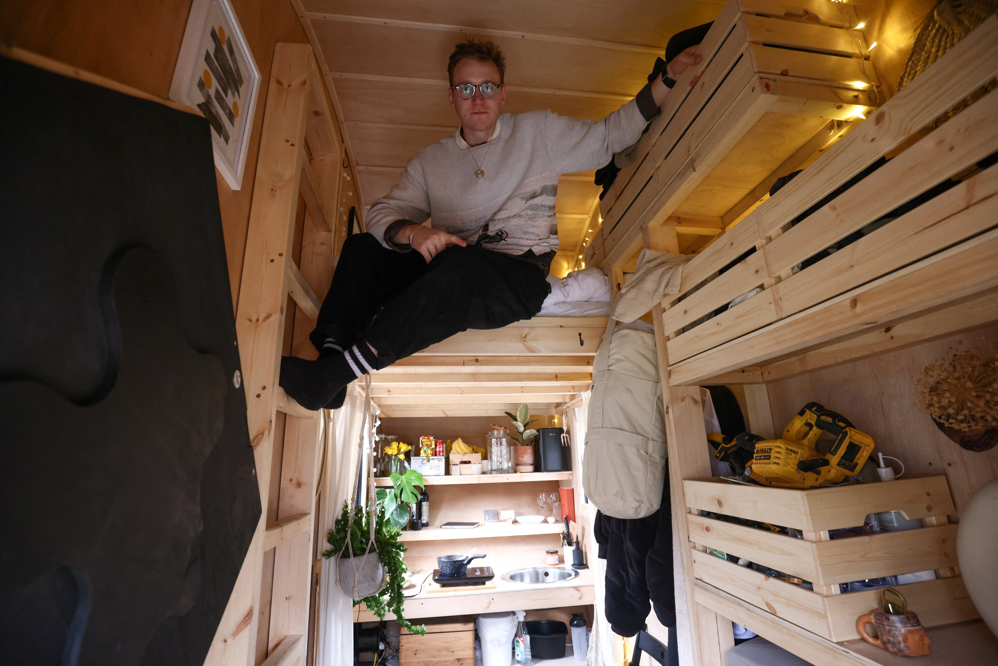 Artist builds home in a rubbish skip to protest against soaring rental ...