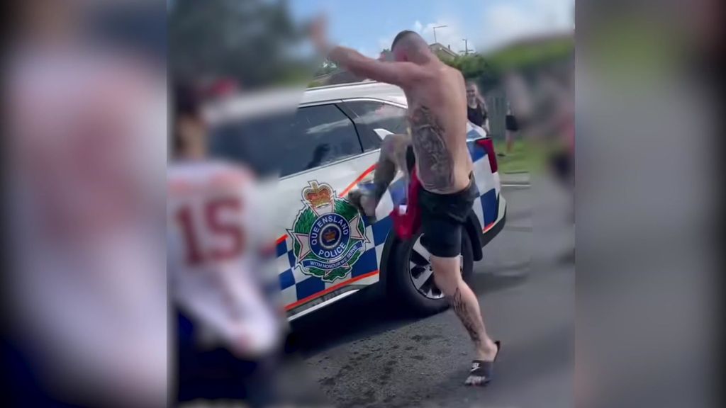 At least one of the men is shown kicking a marked vehicle at what ...