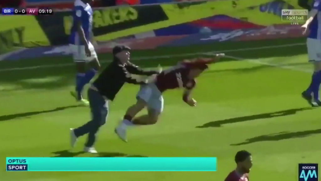 Spectator runs on field and assaults football player - ABC News