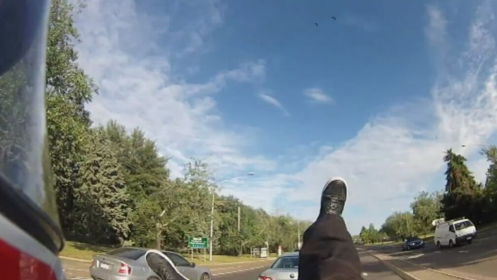 Footage shows motorcyclist landing on feet after being rear ended ...