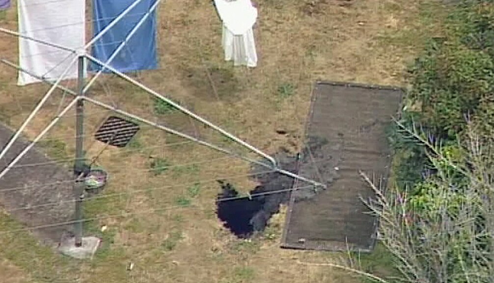 Sinkhole rescue: Woman falls into 3m hole while hanging out washing in ...