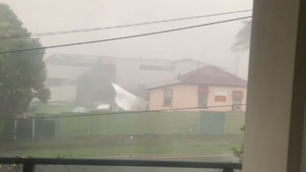 A local captured a roof being blown off a school in Brisbane's bayside ...
