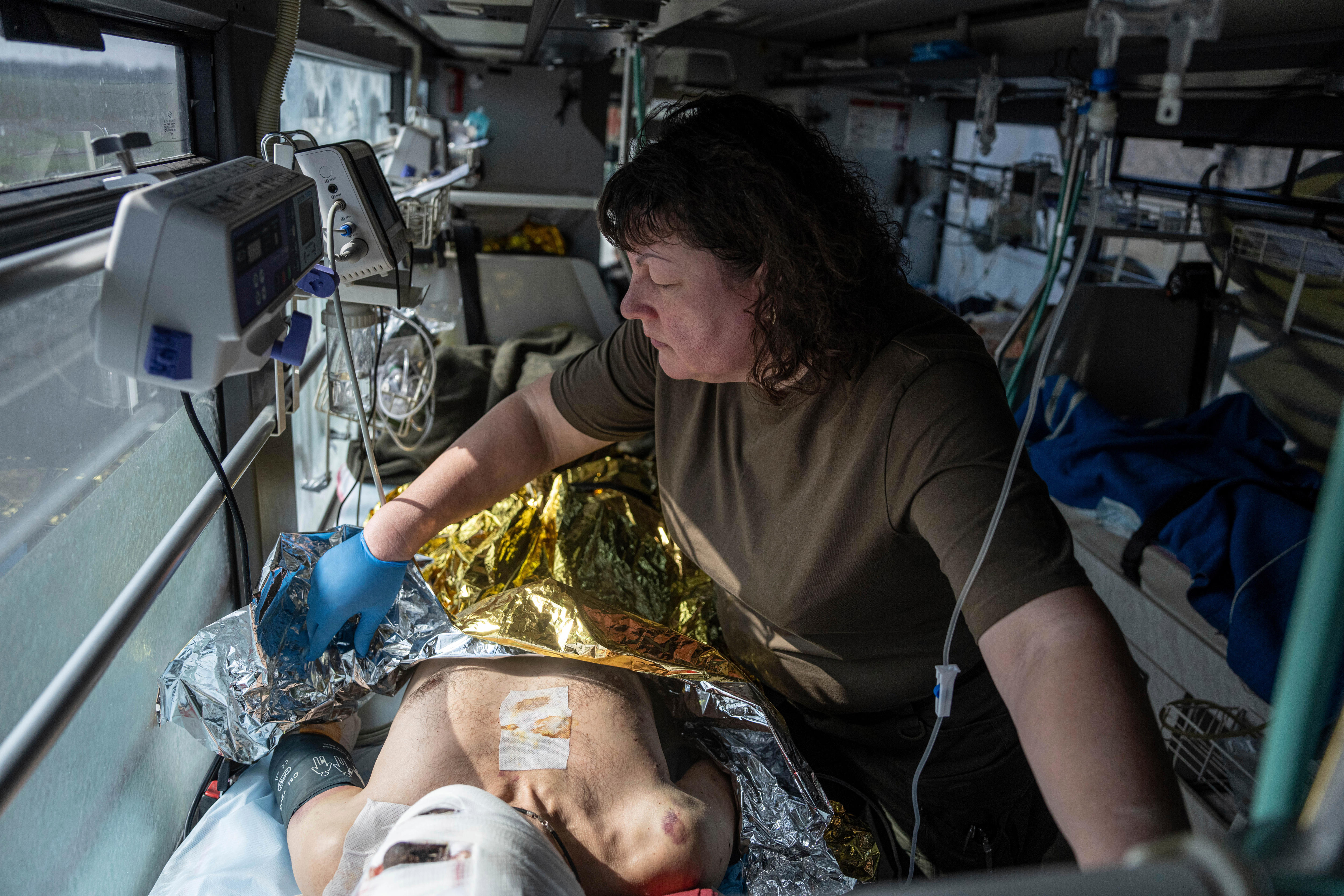 Volunteer paramedics evacuate injured soldiers from the front line in ...