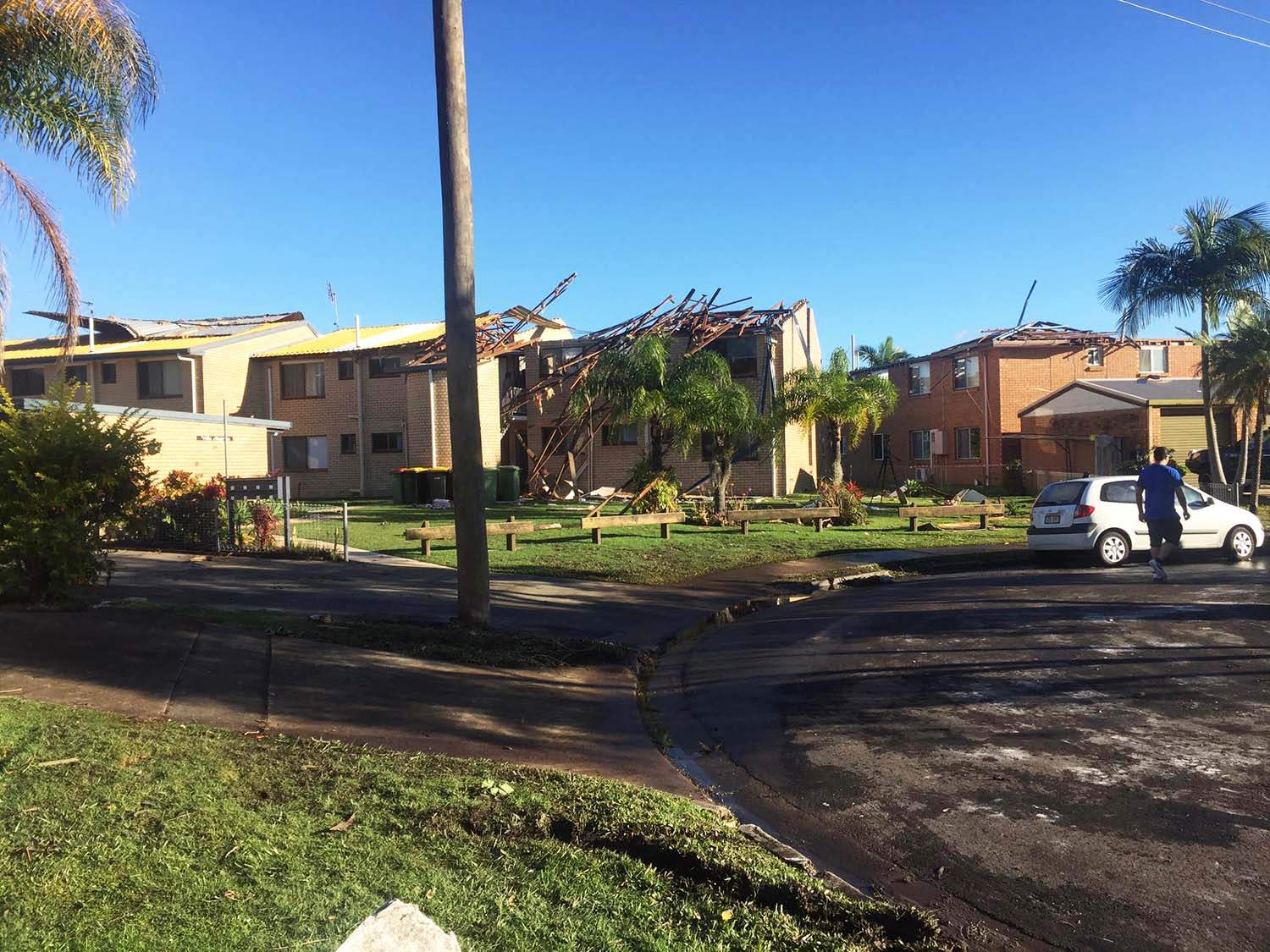 Strong winds tear roofs from unit blocks, trashing cars in Mooloolaba ...