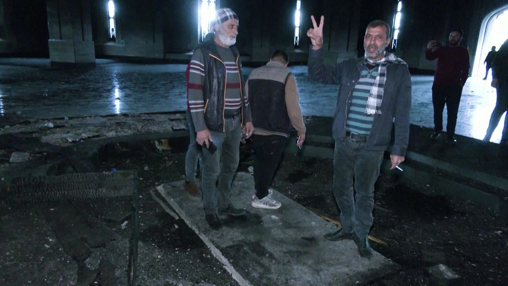 People visit the burnt tomb of late Syrian President Hafez al-Assad ...