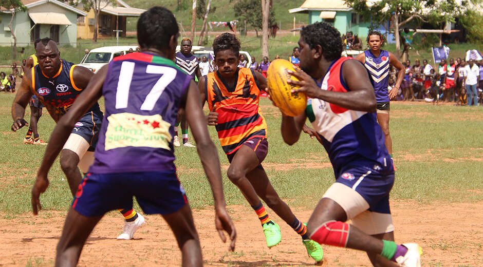 Local police officer kicking goals in effort to keep the peace at ...