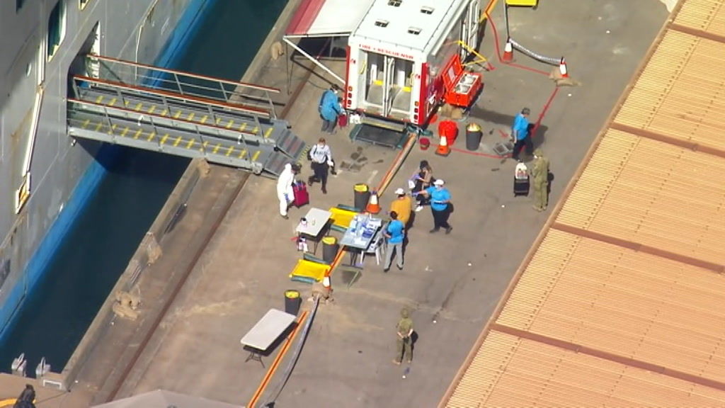 Ruby Princess crew disembark at Port Kembla. - ABC News