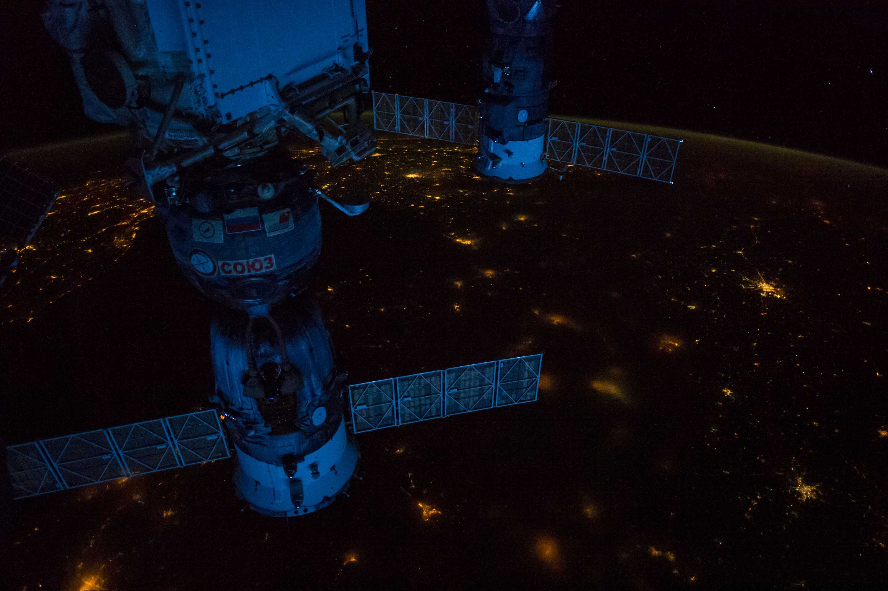 Soyuz spacecraft with multinational crew docks at International Space ...