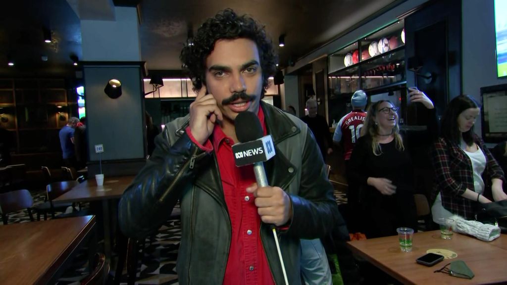 Sports reporter Tony Armstrong celebrating with football fans - ABC News
