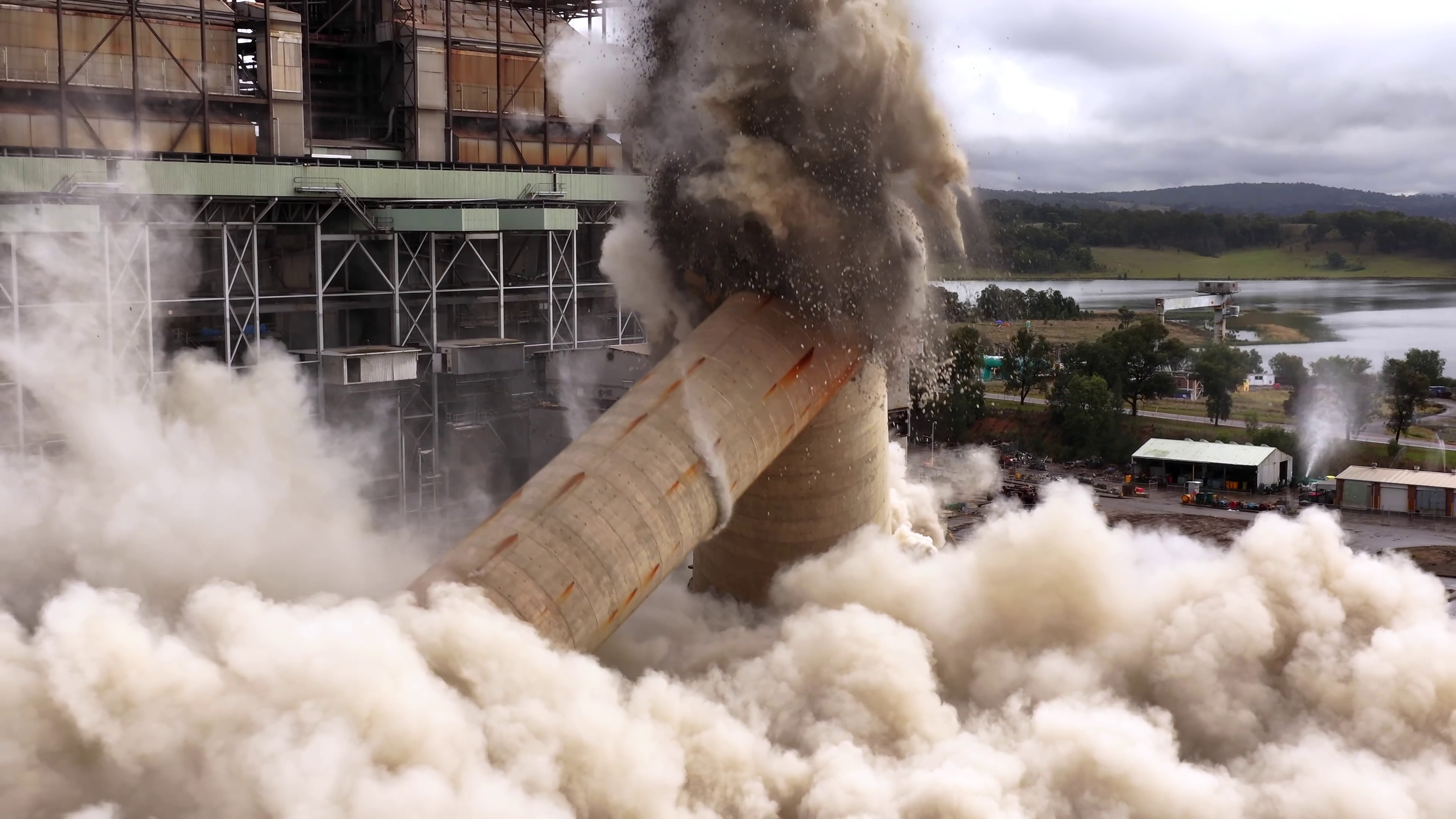 Close-up drone video of two chimneys being demolished at the Liddell ...