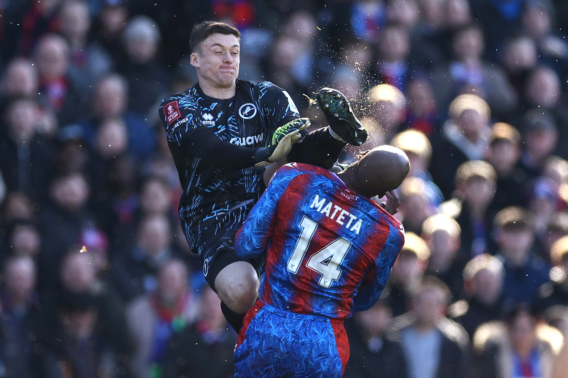 Millwall goalkeeper Liam Roberts karate kicks Jean-Philippe Mateta of Crystal Palace in FA Cup ...