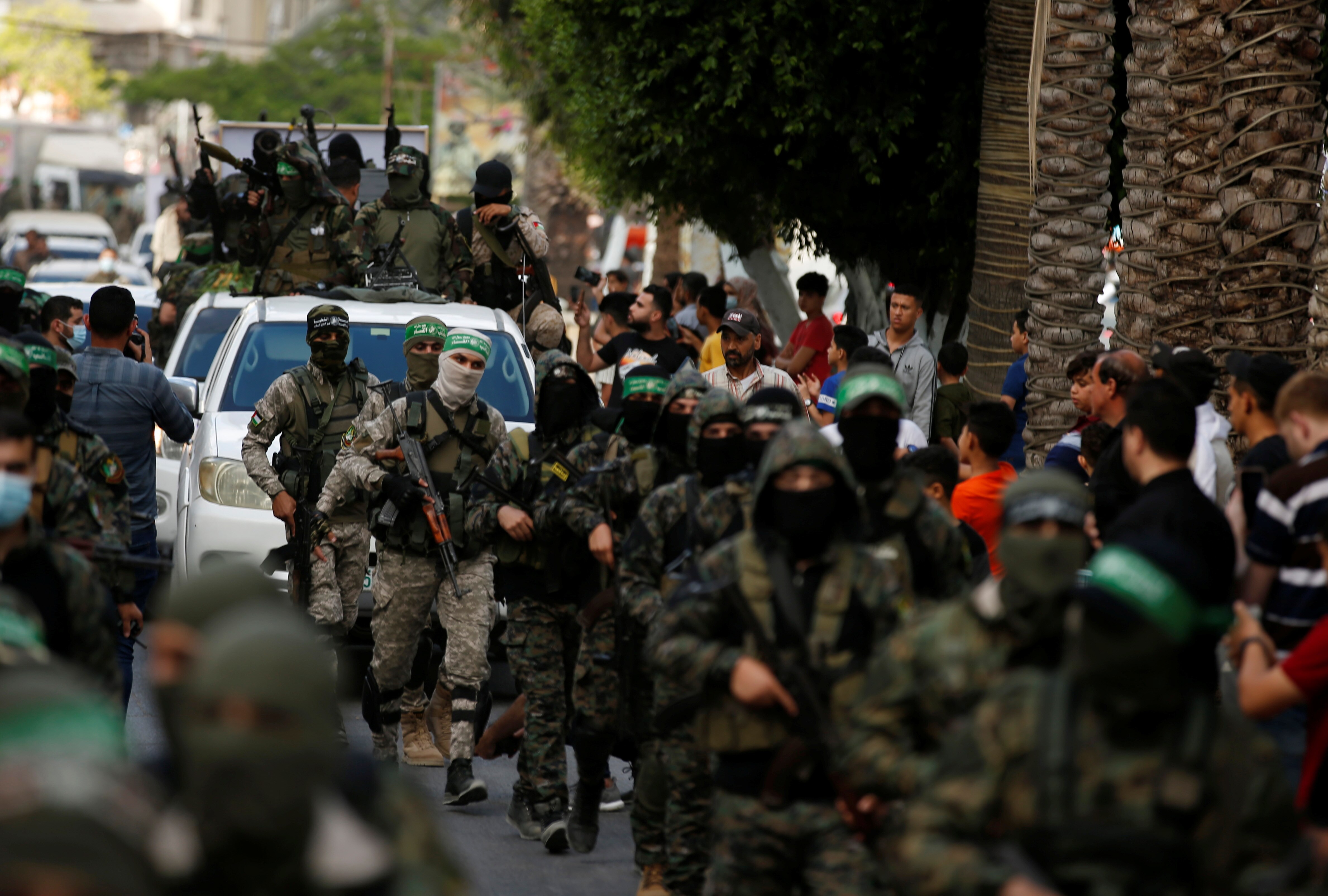 Hamas militants parade in Gaza, humanitarian aid convoy heads to the ...