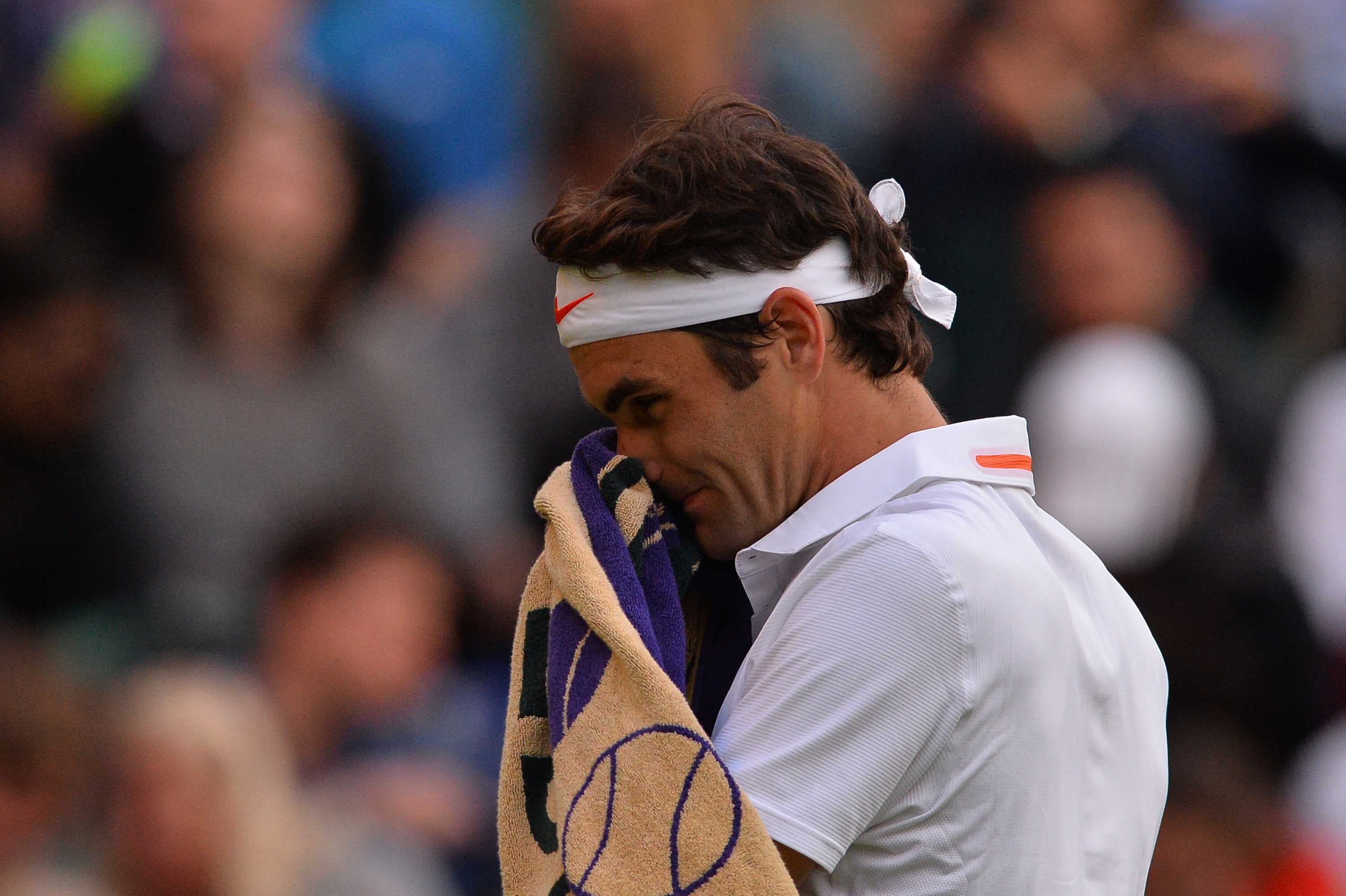 Roger Federer admits he is being treated for back injury after Swiss ...
