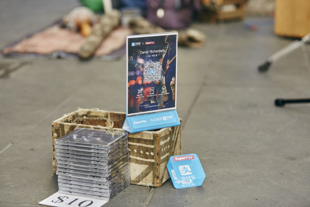 Buskers trial tap-and-go, smartphone payments to combat increasingly ...