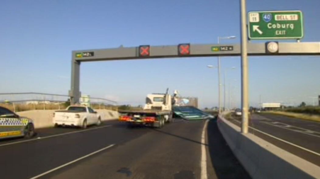 Tullamarine Freeway sign falls and crushes car, injuring Melbourne ...