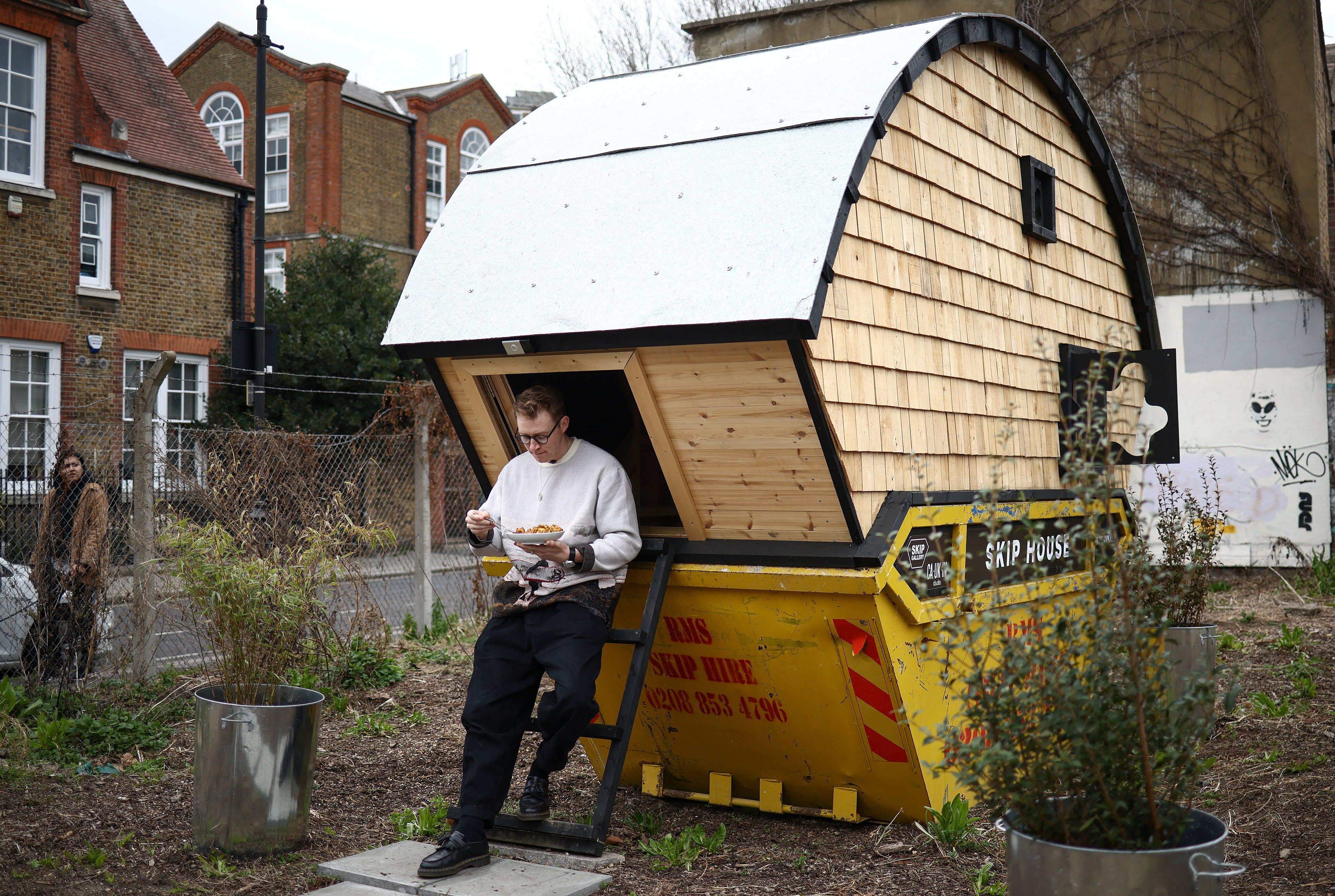Artist builds home in a rubbish skip to protest against soaring rental ...