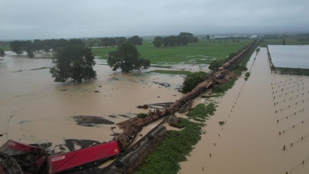 Freight train derails in flood waters near New Zealand's North Coast ...