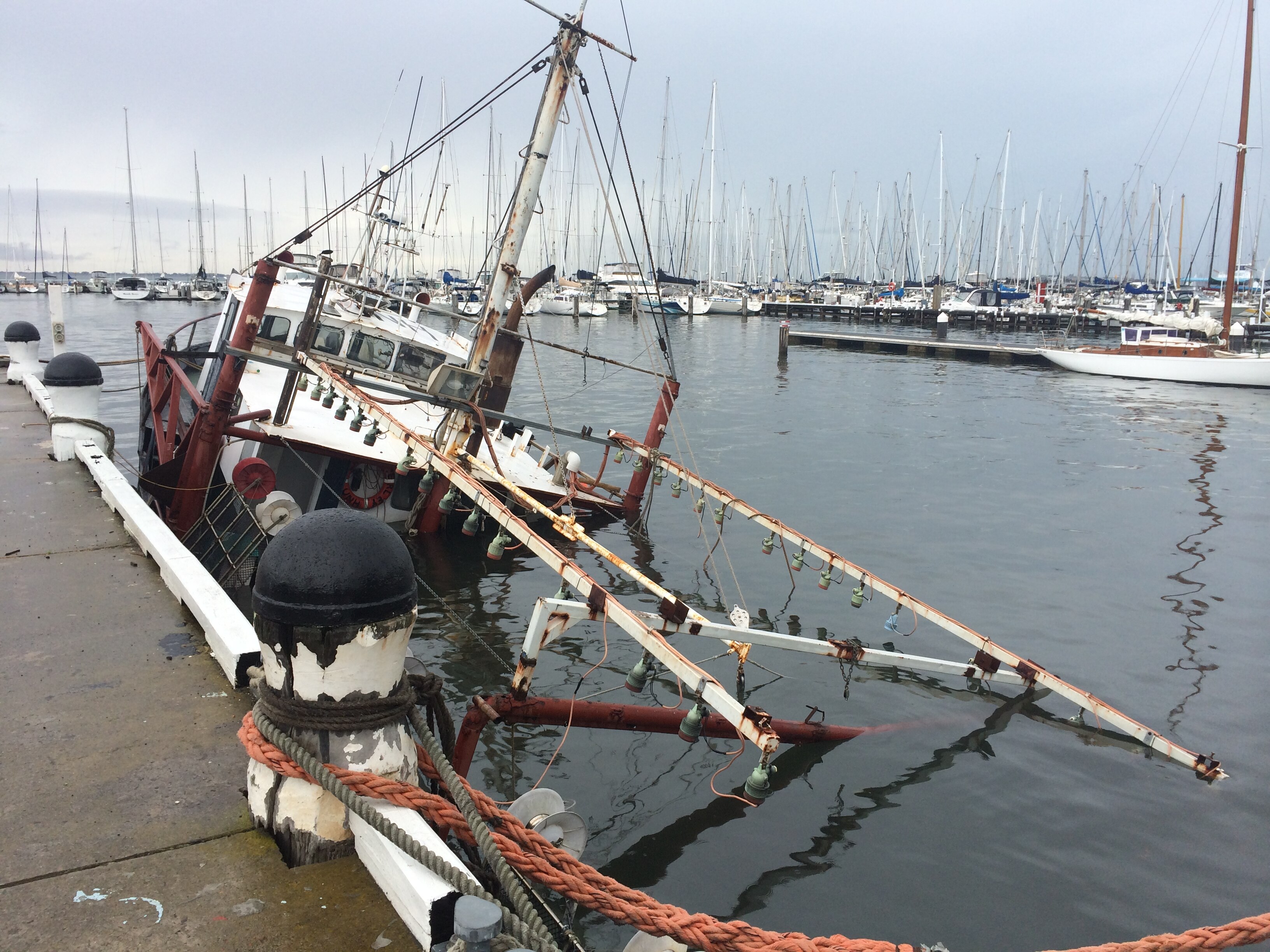 Cleanup experts work on oil spill caused by sunken fishing boat in ...