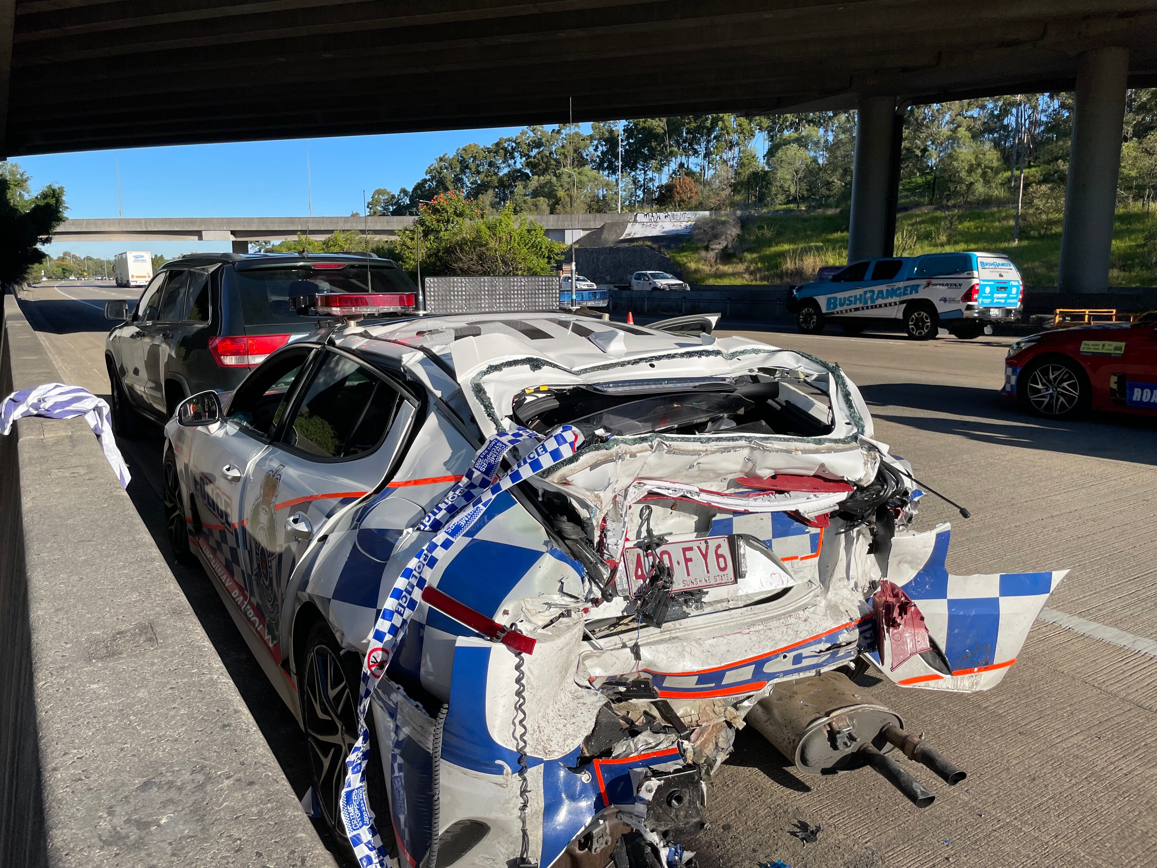 Firefighters cut patients out of crash after parked police car hit at ...