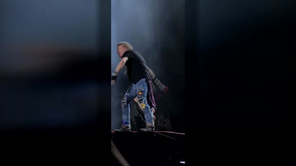 Axl Rose throws his microphone into the crowd. - ABC News