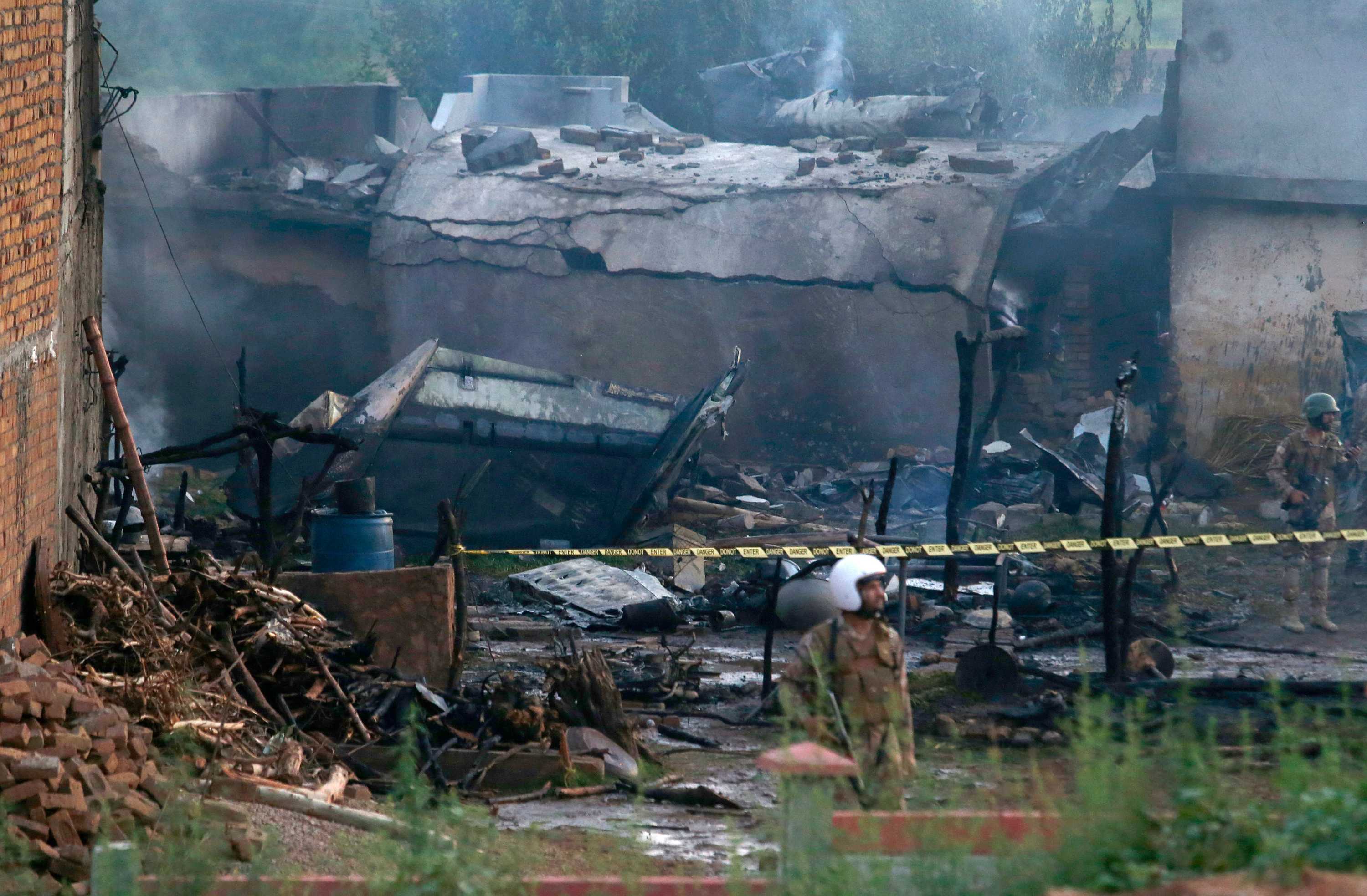 Pakistan army plane crashes into village, killing at least 18 people ...