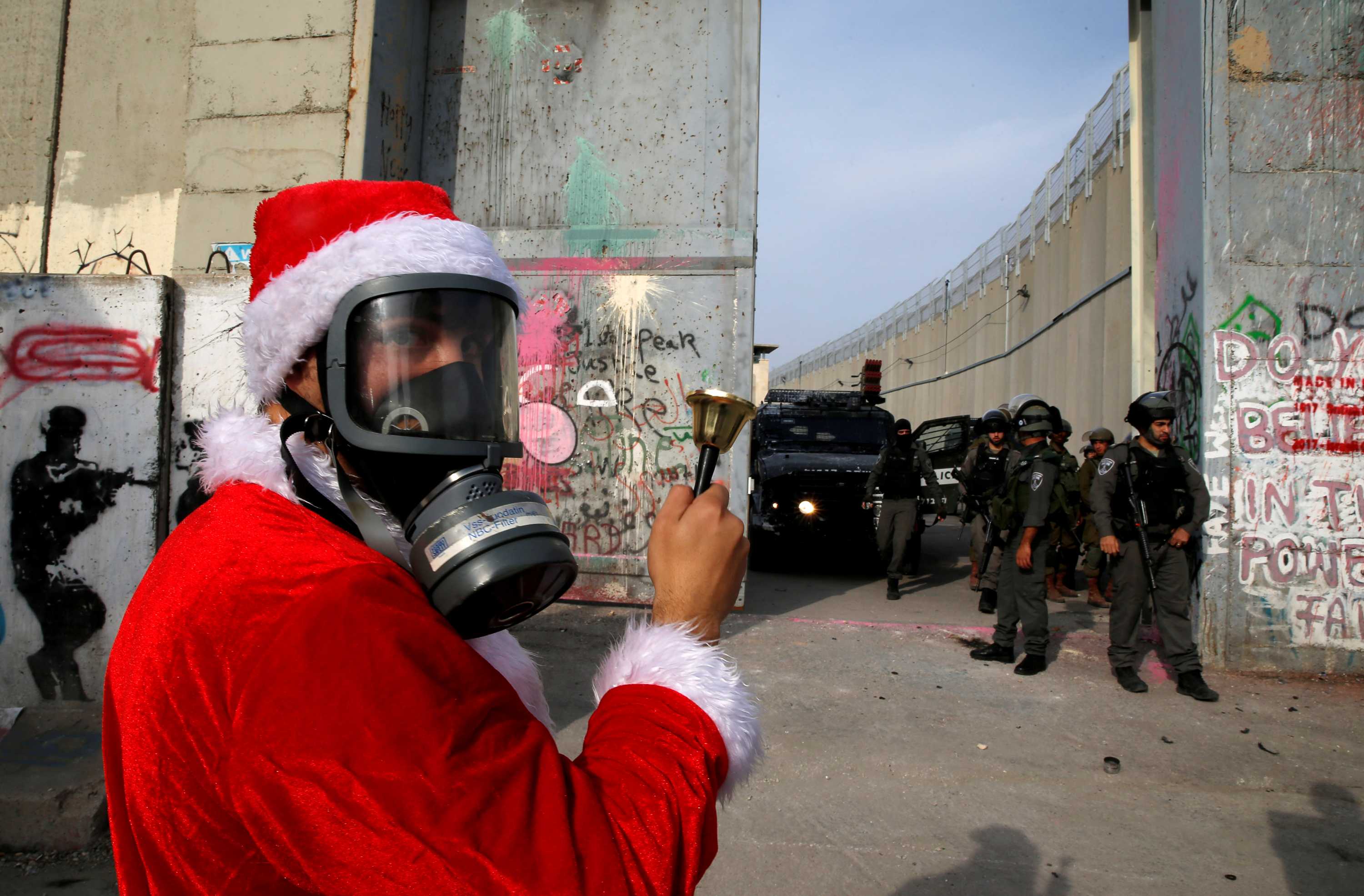 Palestinians dressed as Santa clash with Israeli forces in Bethlehem ...