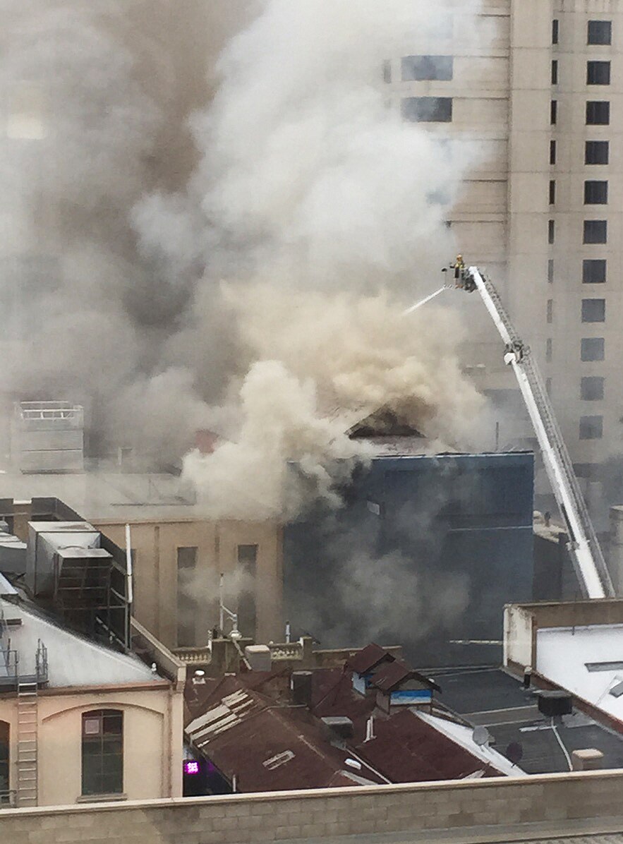 Fire crews extinguish large blaze in Adelaide's CBD; building's roof ...