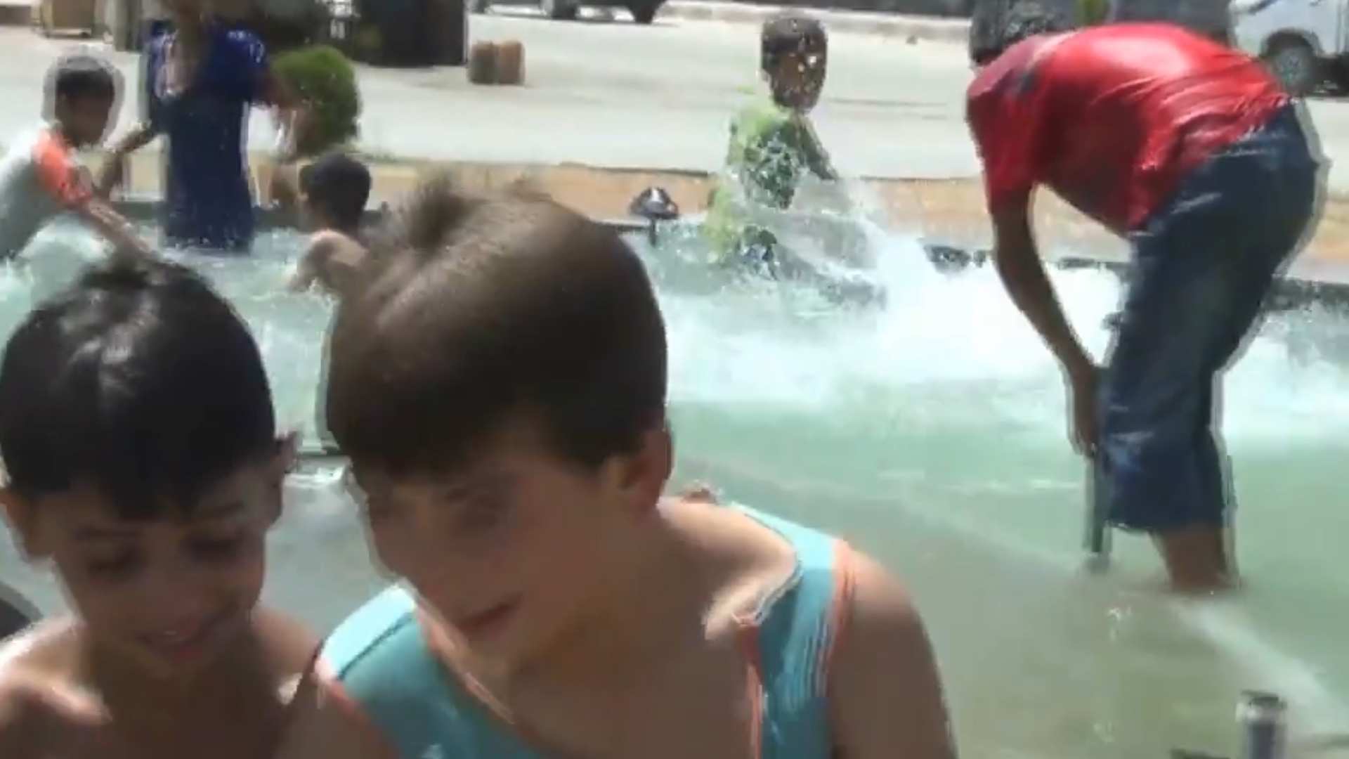 Kids play in the pool at Naim Square in August 2013. - ABC News