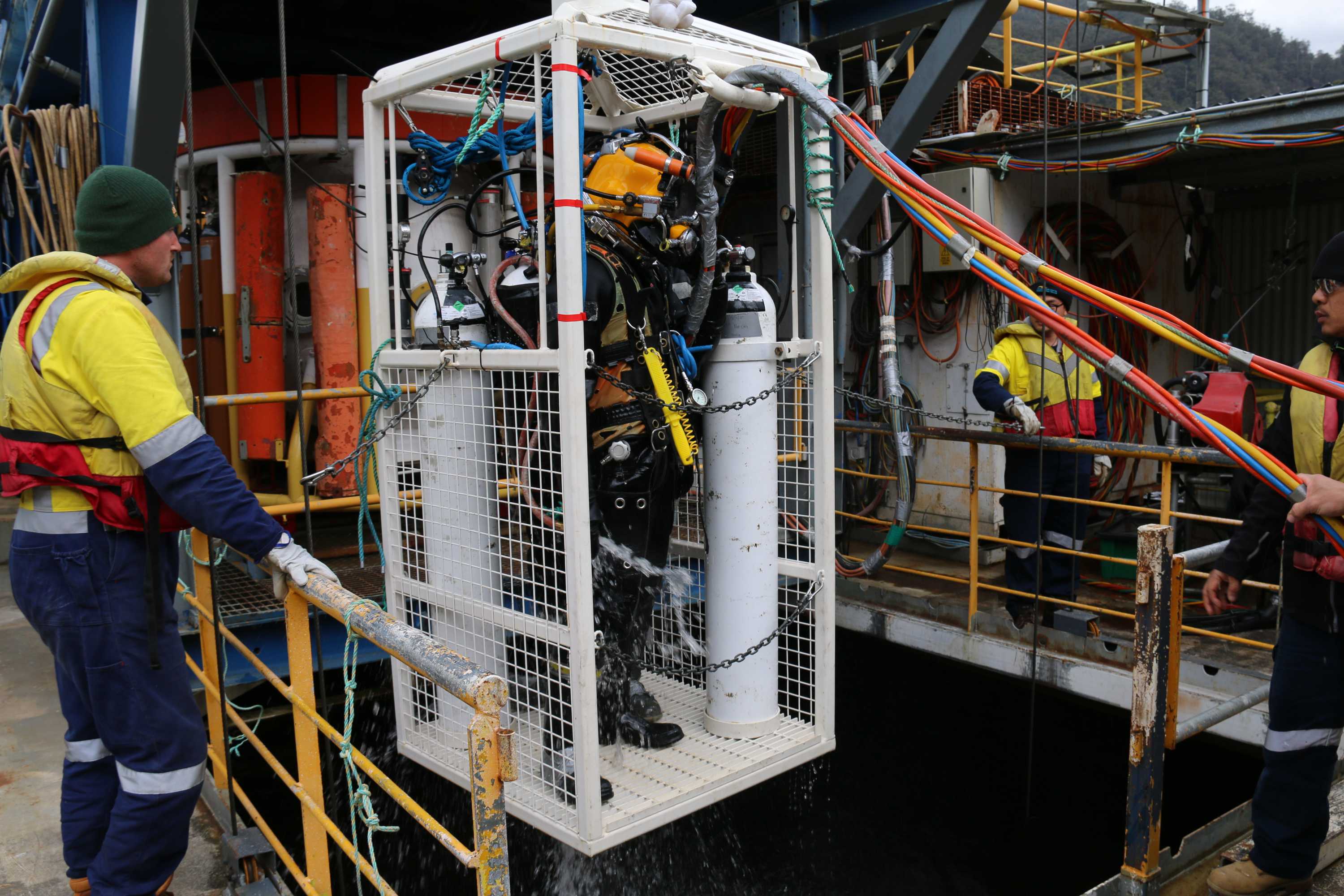 Divers train up to 100 metres below surface at remote Tasmanian lake ...