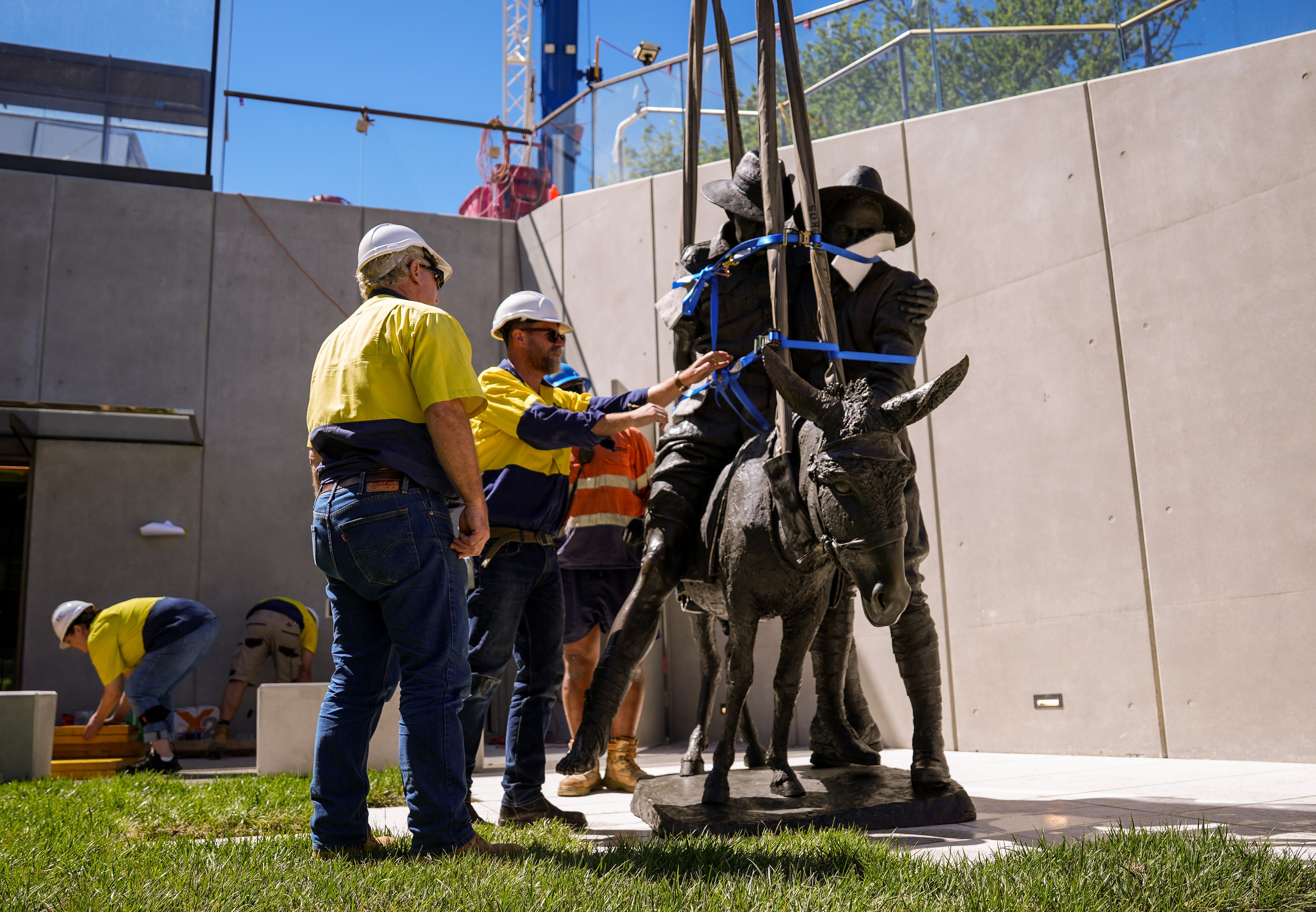 Iconic sculpture of Simpson and his donkey craned back into position at ...