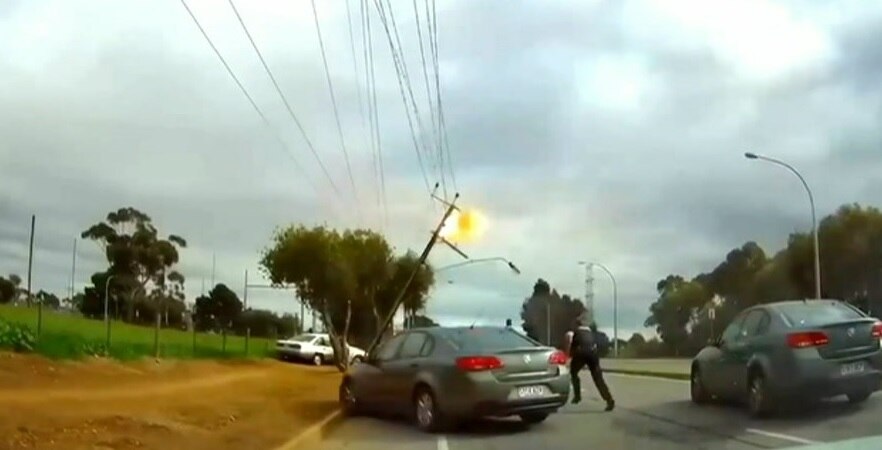Footage shows car crashing into power pole, bringing down powerlines ...