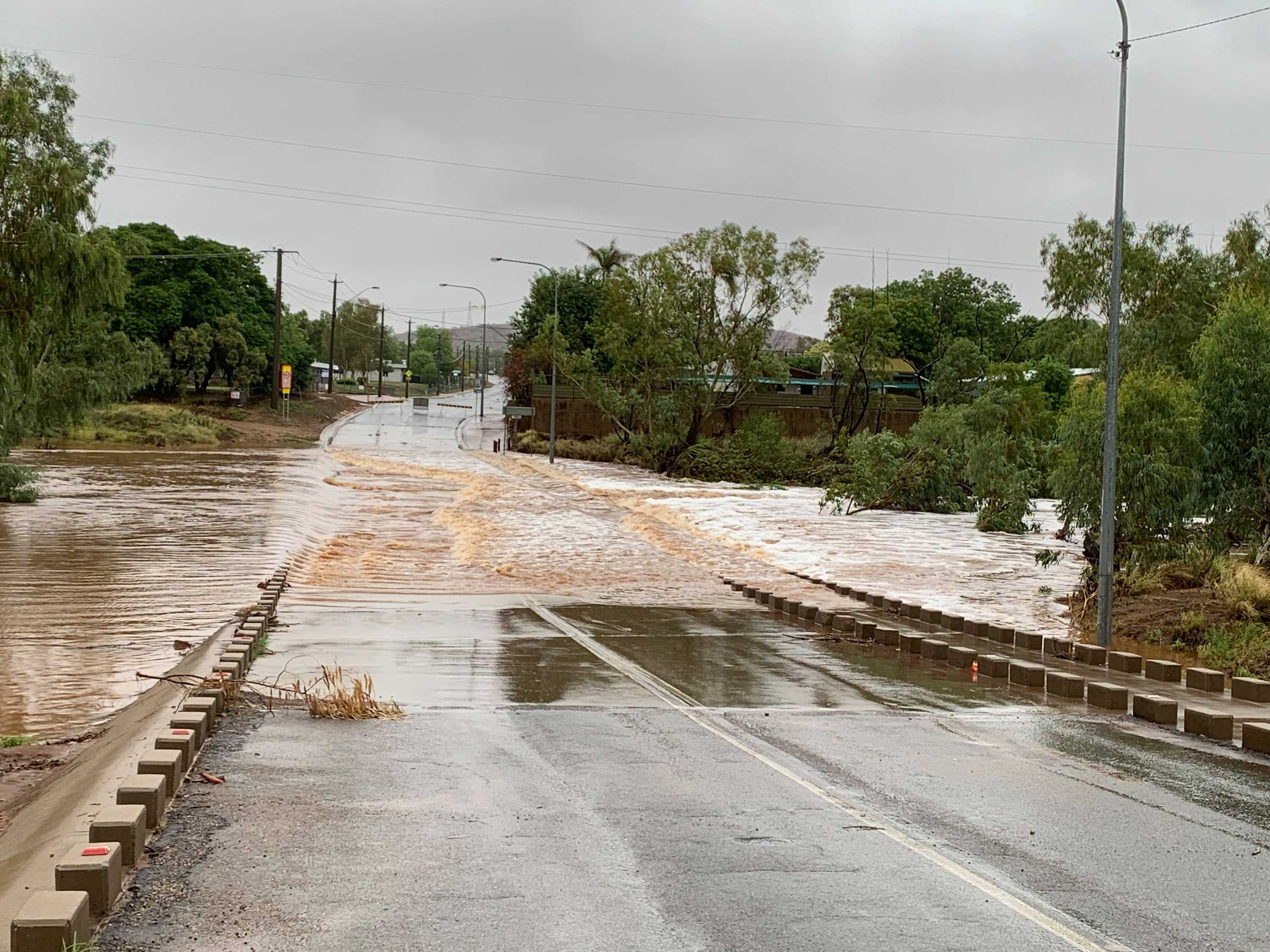 Monsoonal rain welcomed in Mount Isa as floodwaters close roads, but no ...