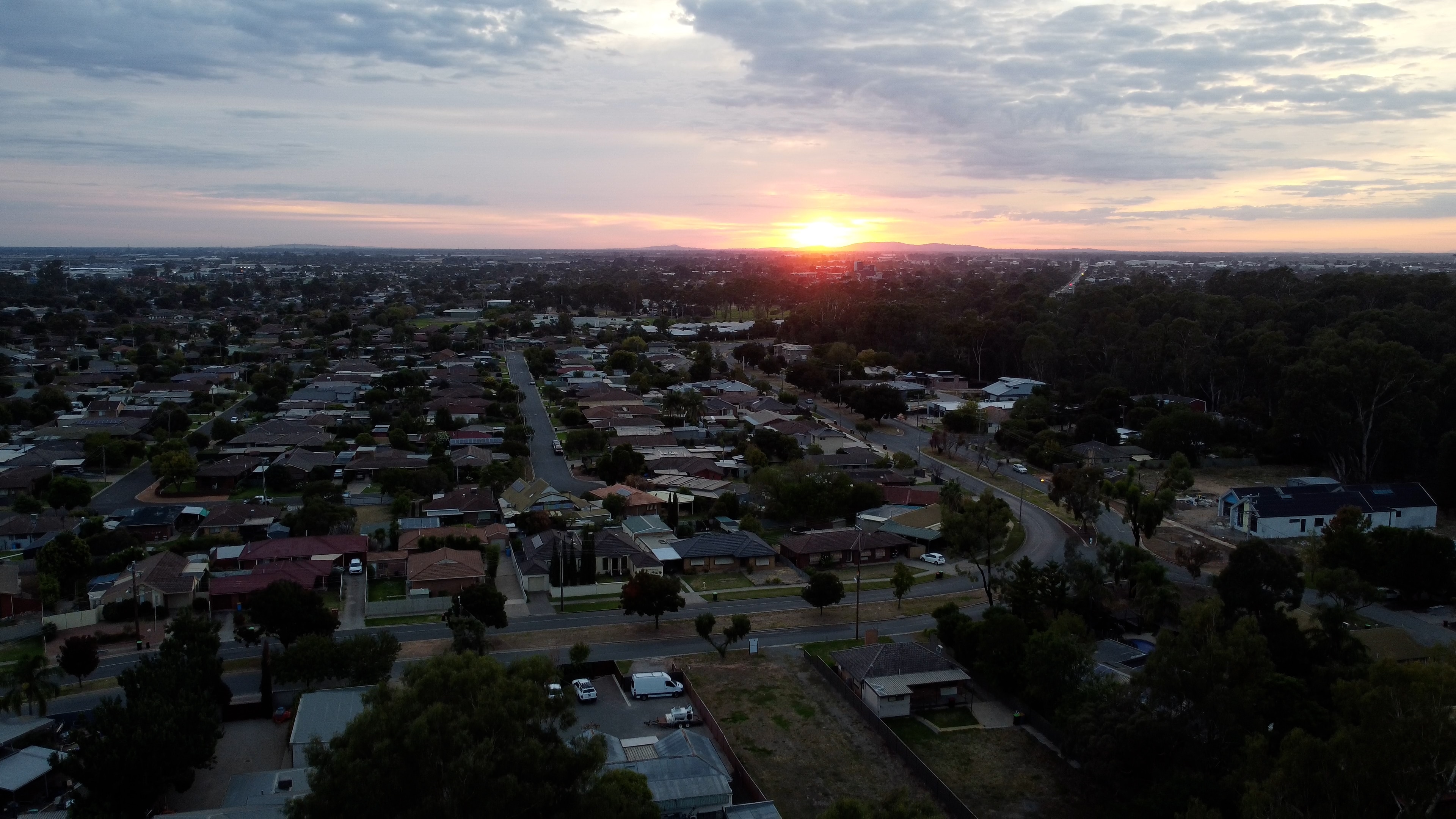 Drone vision of the roofs of Shepparton as the sun sets - ABC News