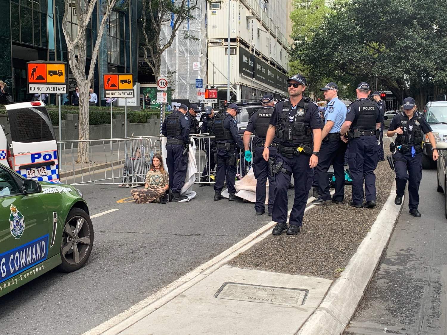 Extinction Rebellion protesters chained by the neck to fencing in ...