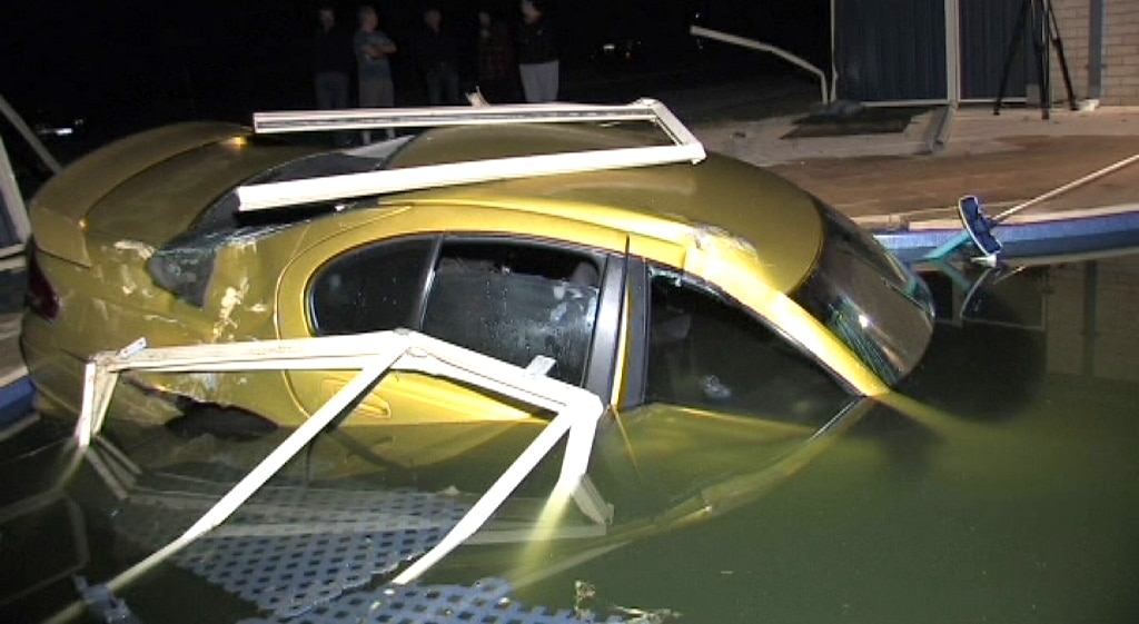 Stolen car crashes into fence, lands in backyard pool - ABC News