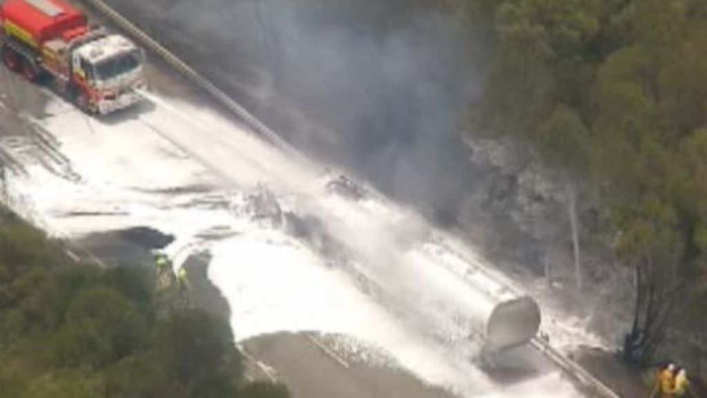 Emergency services put out the fire caused by two trucks crashing on ...