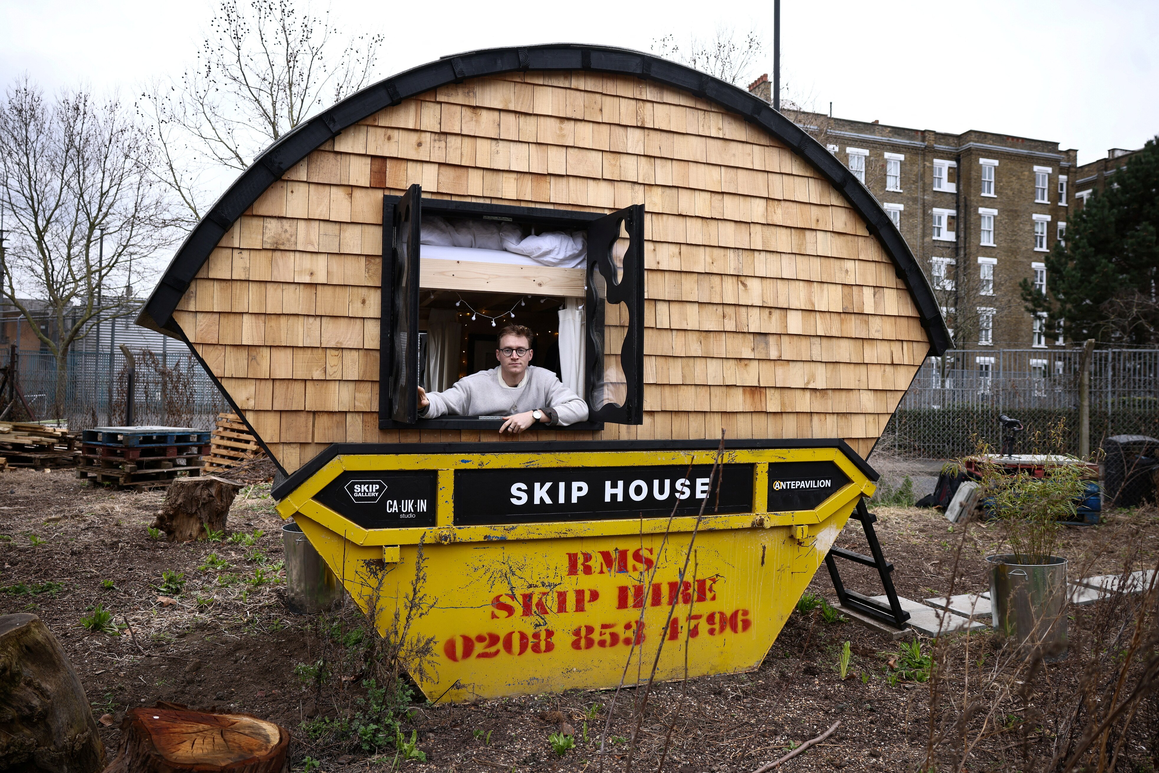 Artist builds home in a rubbish skip to protest against soaring rental ...
