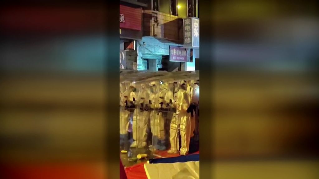 Protesters throw glass bottles at riot police in Guangzhou - ABC News