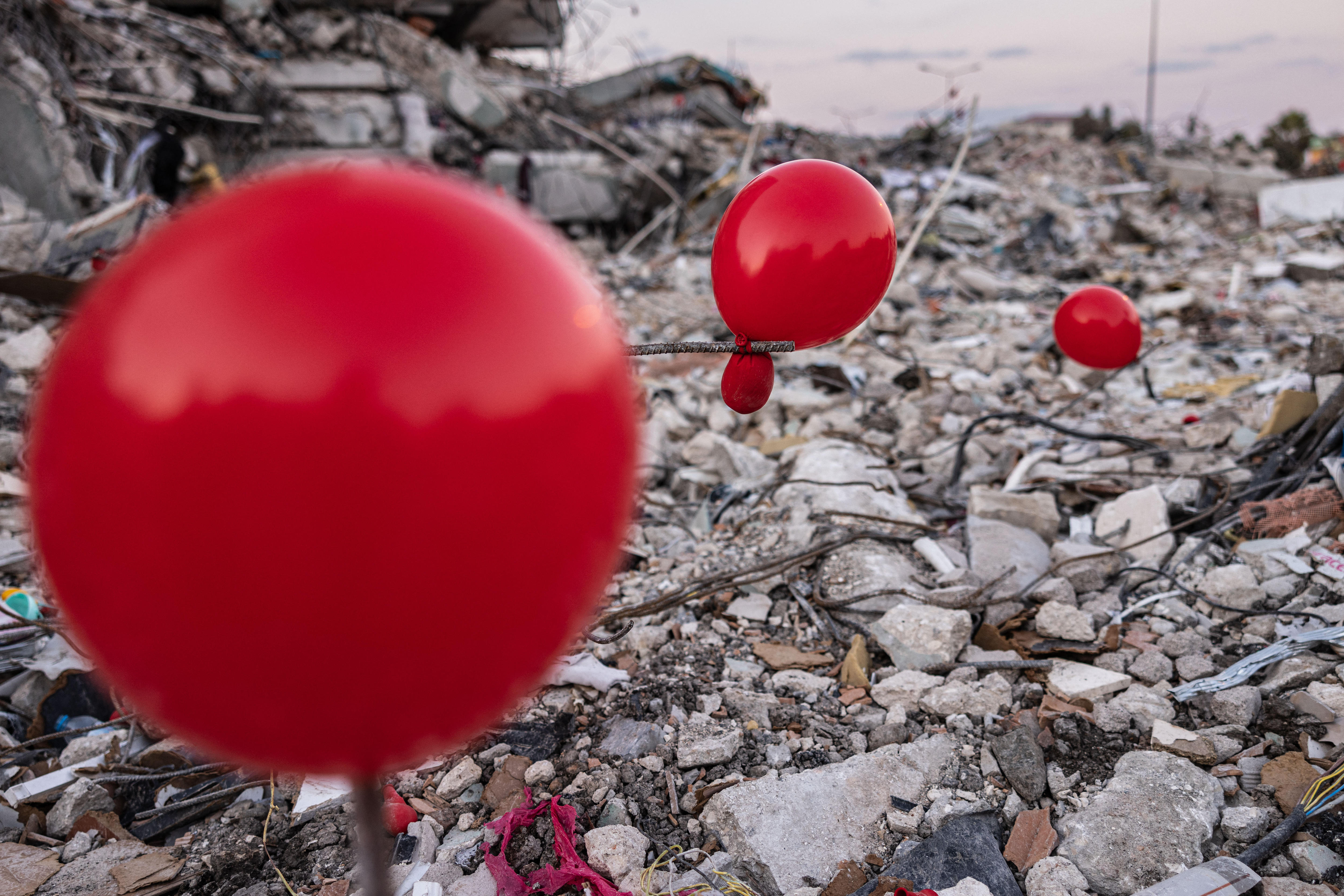 Red balloons mark places where children were killed in devastating ...