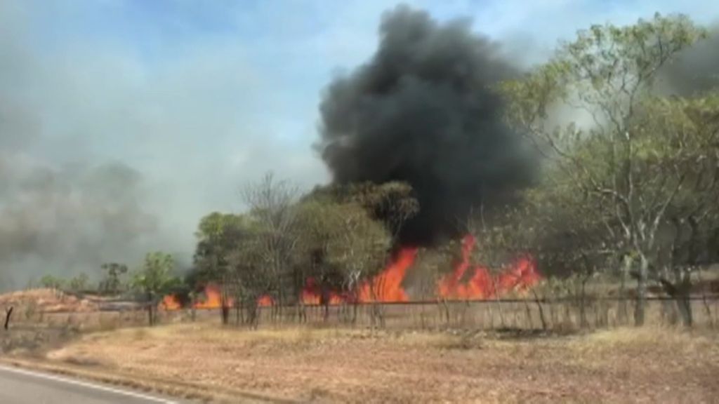 A fire on the Stuart Highway near Adelaide River is burning out of ...