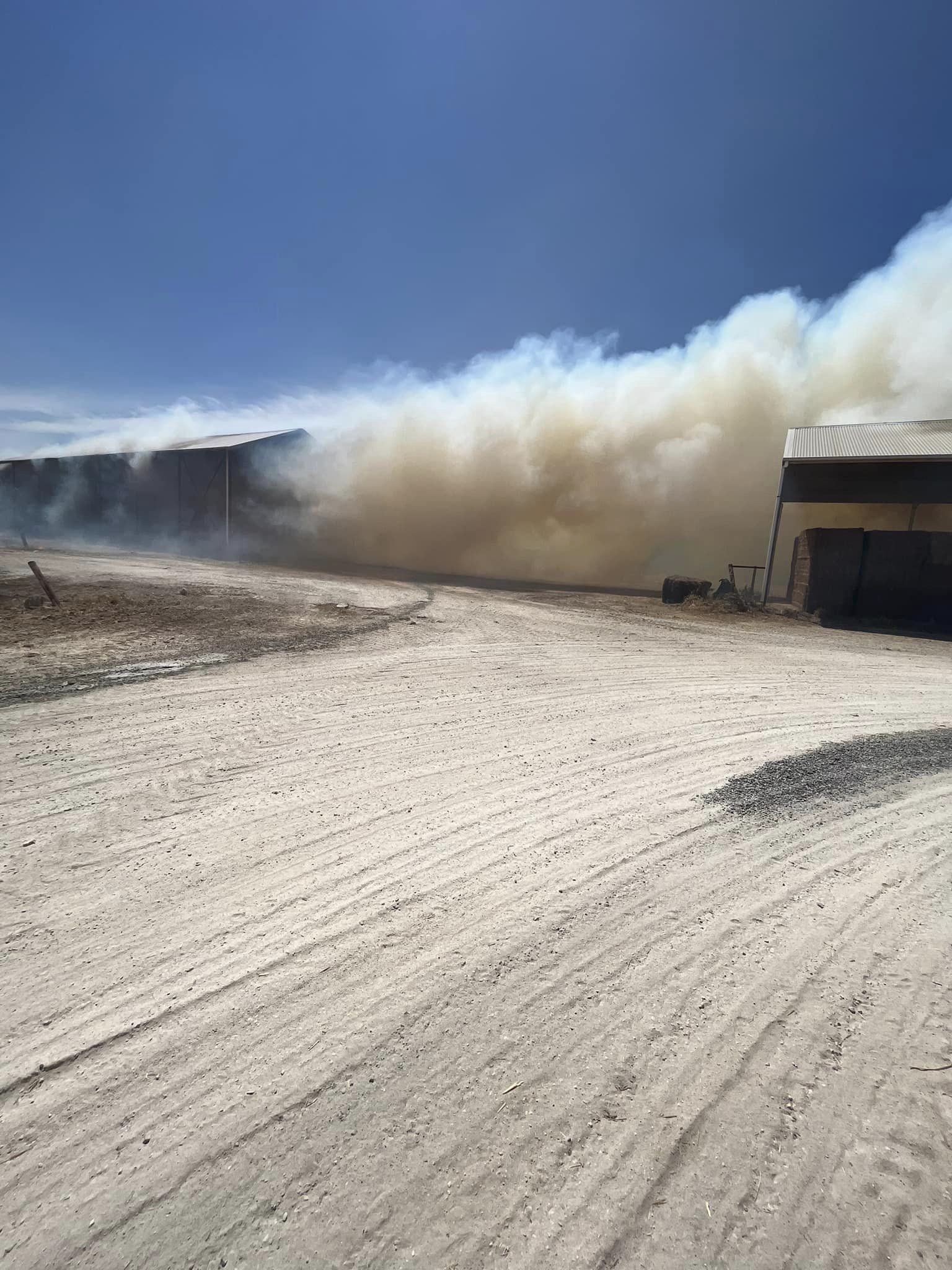 Crews work through night to contain 'fire storm' as 6,000 hay bales ...