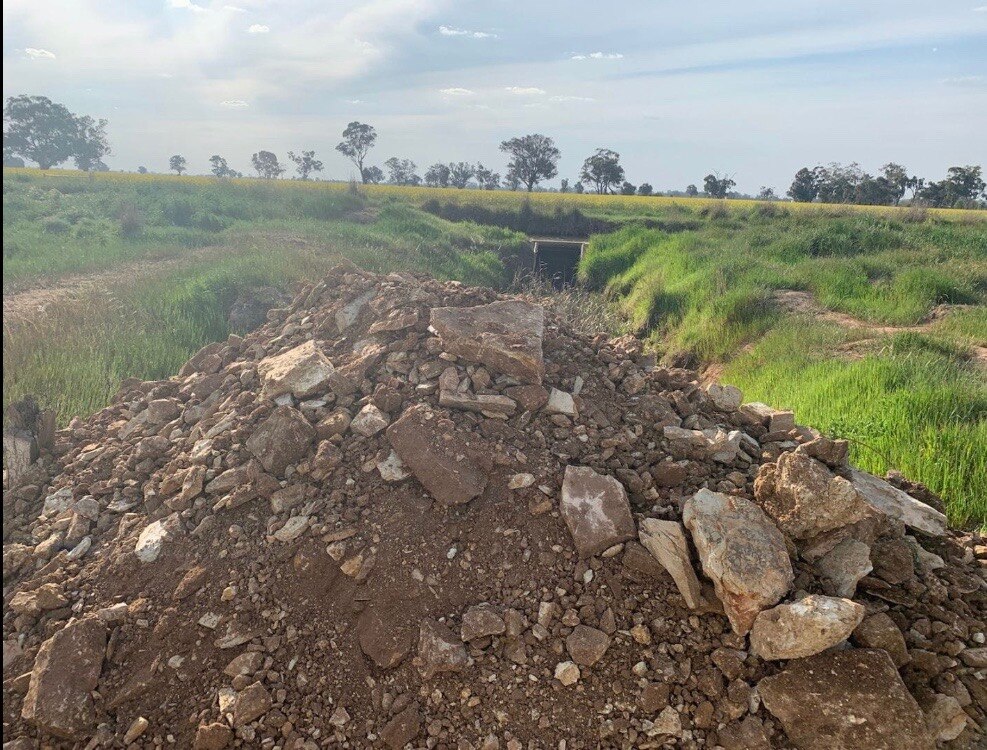 Dumped gravel and rock blocks environmental water from flowing into ...