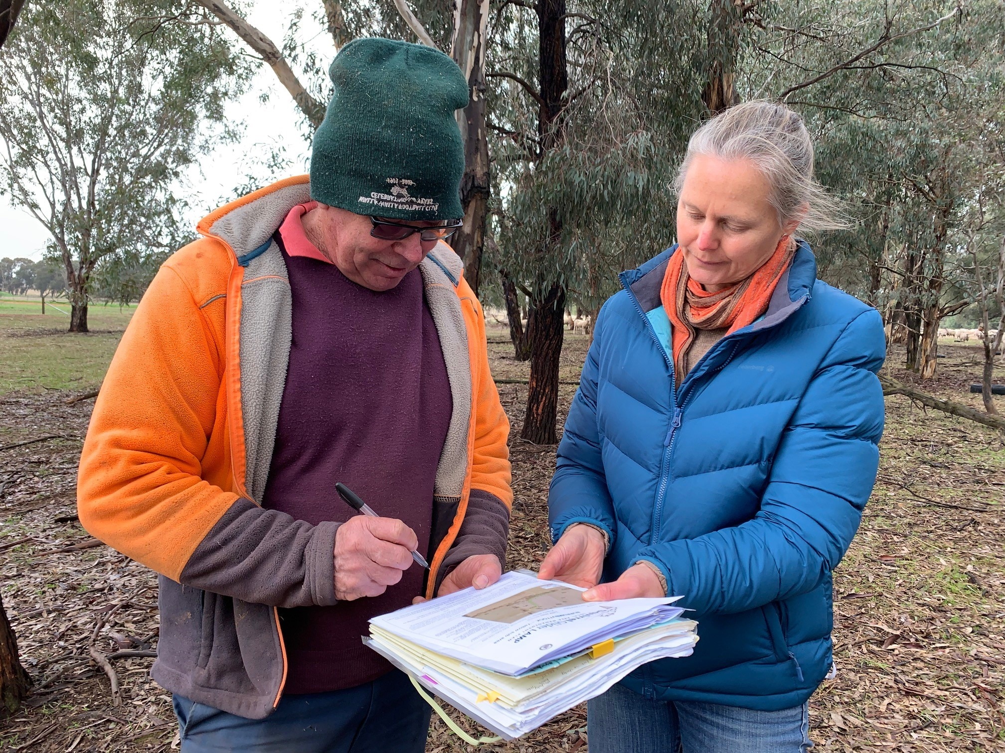 Project officer Lou Bull and farmer Trevor Barber discuss a project to ...