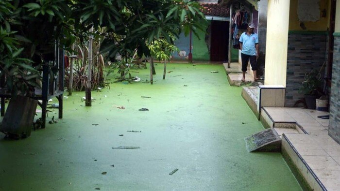 Indonesian town turns blood red after flood hits batik textiles factory ...